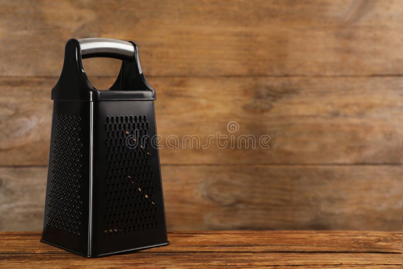 Modern Black Grater on Wooden Table. Space for Text Stock Image - Image ...