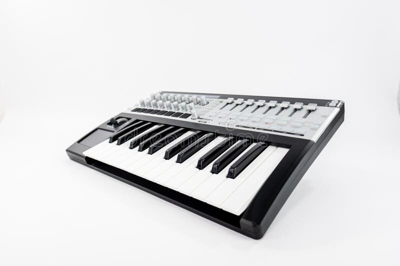 Modern Black and White MIDI Keyboard with Control Pads in a Studio ...