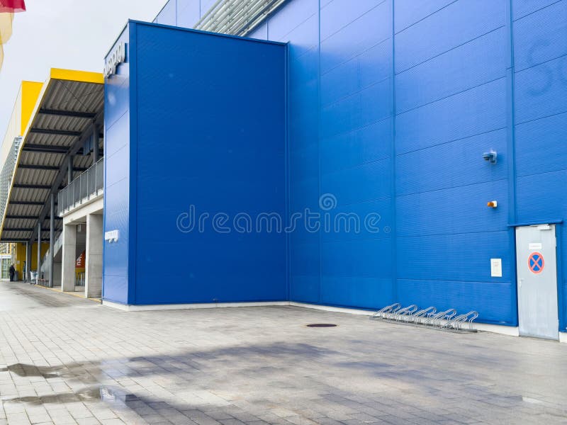 Modern Blue Building Exterior with Bicycle Racks on Overcast Day ...