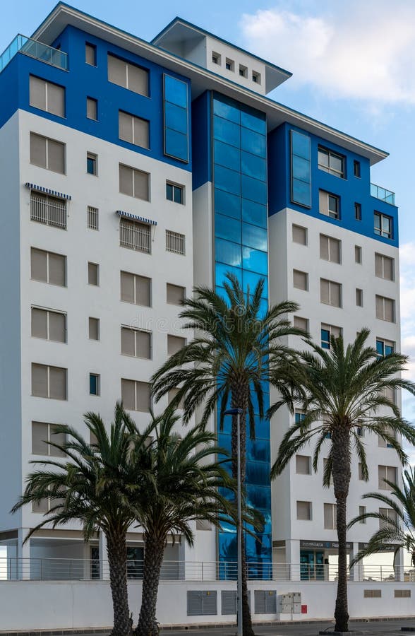 Modern Blue and White Multi-storey Hotel Building with Palm Trees in ...