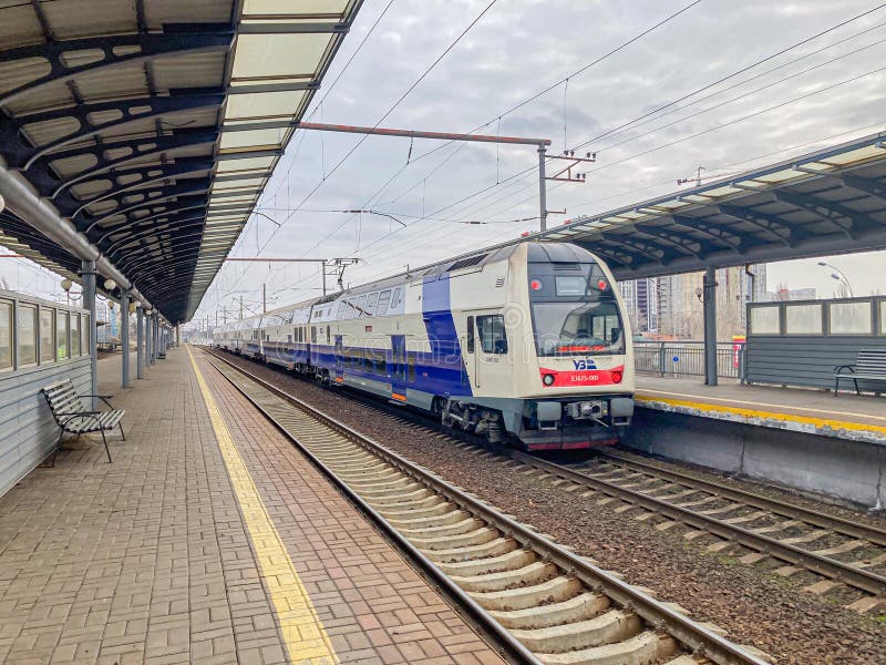 A Modern Blue-white Train is Pulling into an Old Brick Platform at a ...