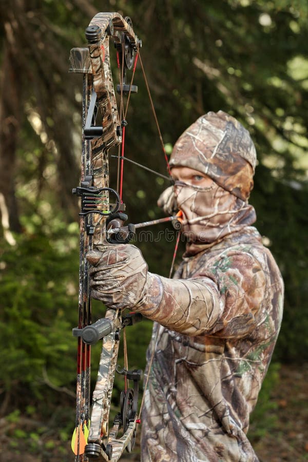 Modern bowhunter in woods stock image. Image of nature - 206176245