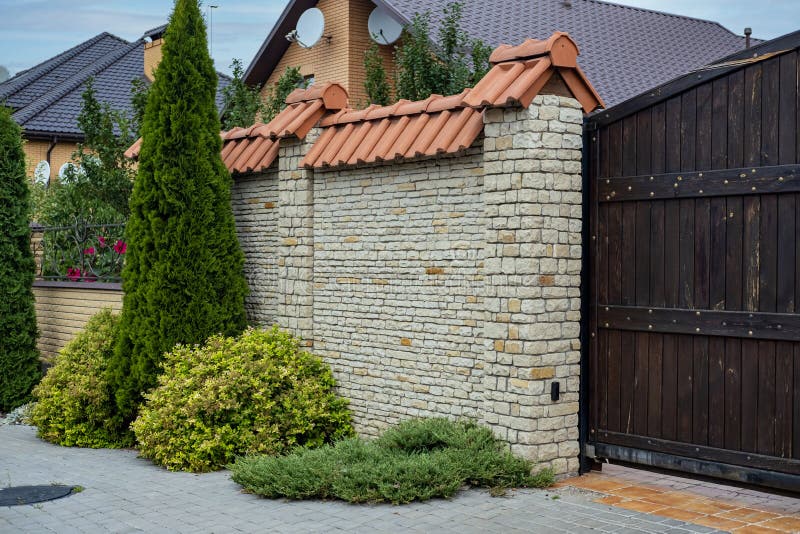 Modern Brick Pattern of Light Stone Fence Wall with Tiles in Front of a ...