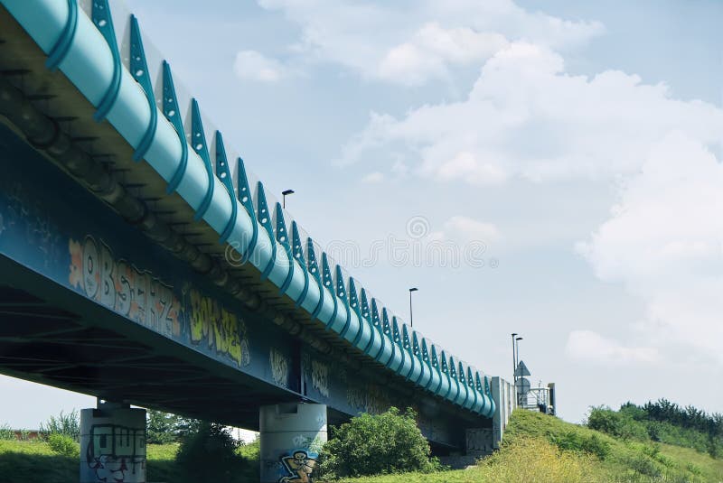 Modern Bridge Over Highway with Graffiti, Beautiful Blue Sky and White ...