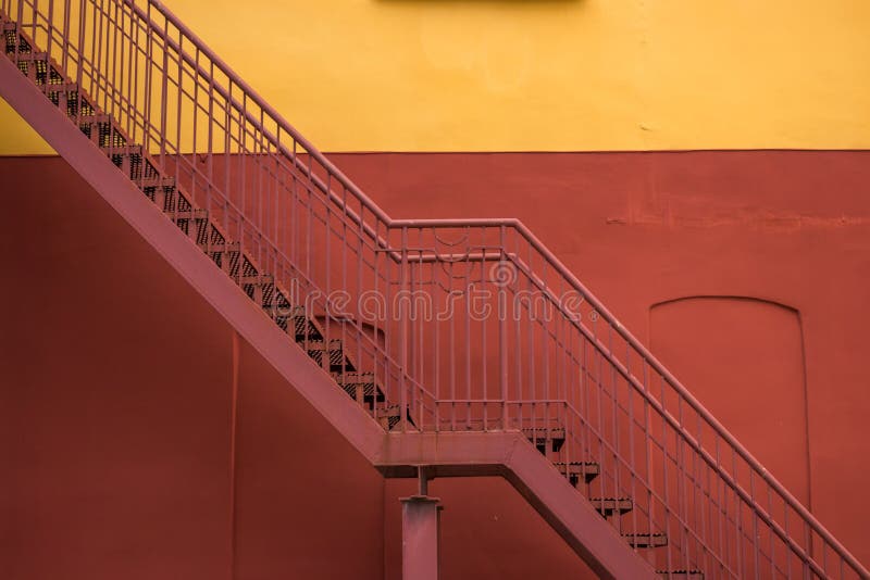 Modern Building is Burgundy Yellow with an Emergency Exit Fire Metal ...