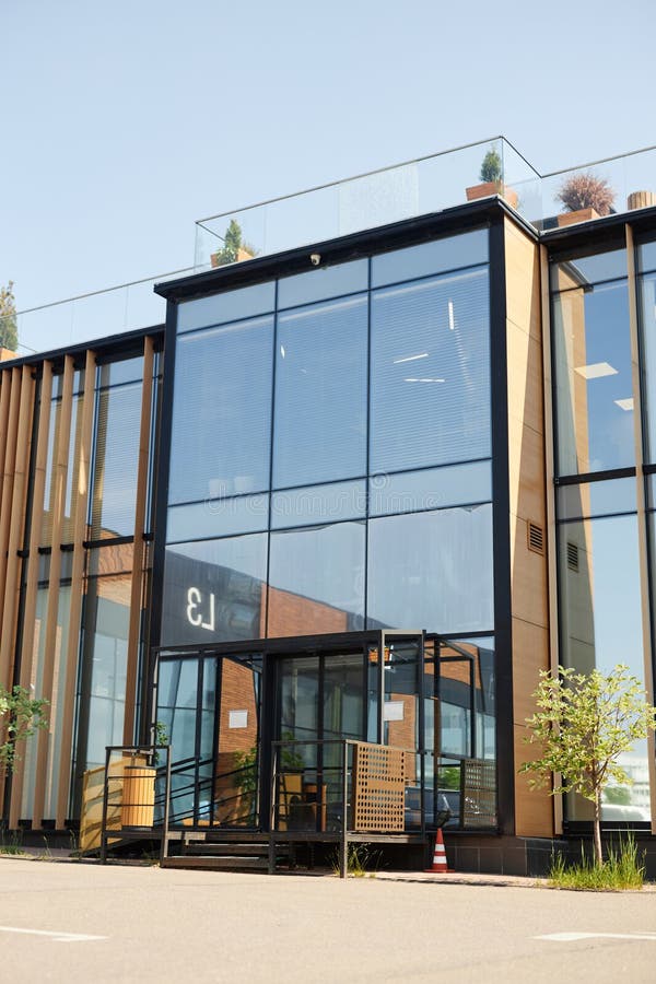 Modern Building Entrance with Glass Facade and Wooden Elements Stock ...