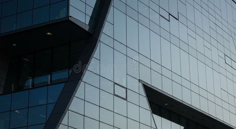 Modern Building Façade Featuring Large Glass Panels Arranged in ...