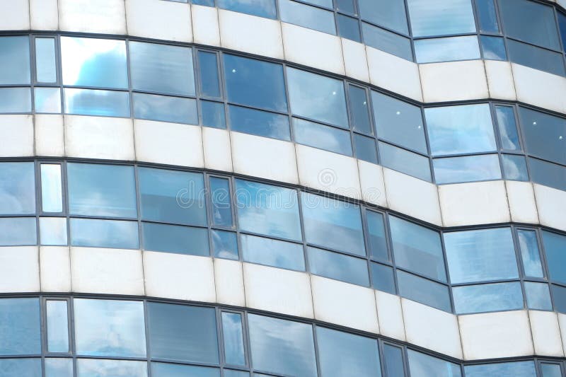 Modern Building Facade with Curved Glass Windows Reflecting Skies Stock ...