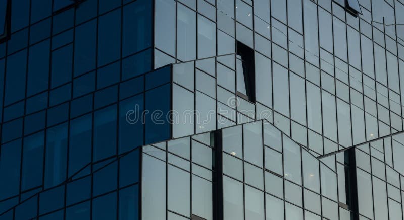 Modern Building Facade Featuring a Geometric Glass Design with Angular ...