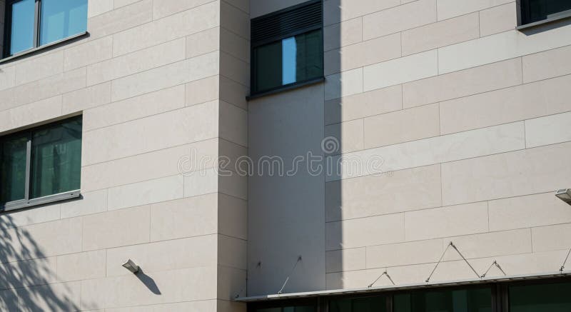 Modern Building Facade with Large Rectangular Beige Stone Panels and ...
