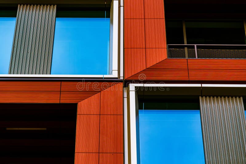 Modern Building Facade with Red and White Panels and Reflective Glass ...