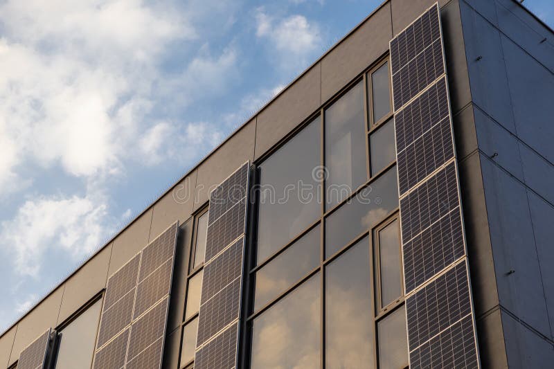 Modern Building Facade with Vertical Solar Panels and Large Glass ...