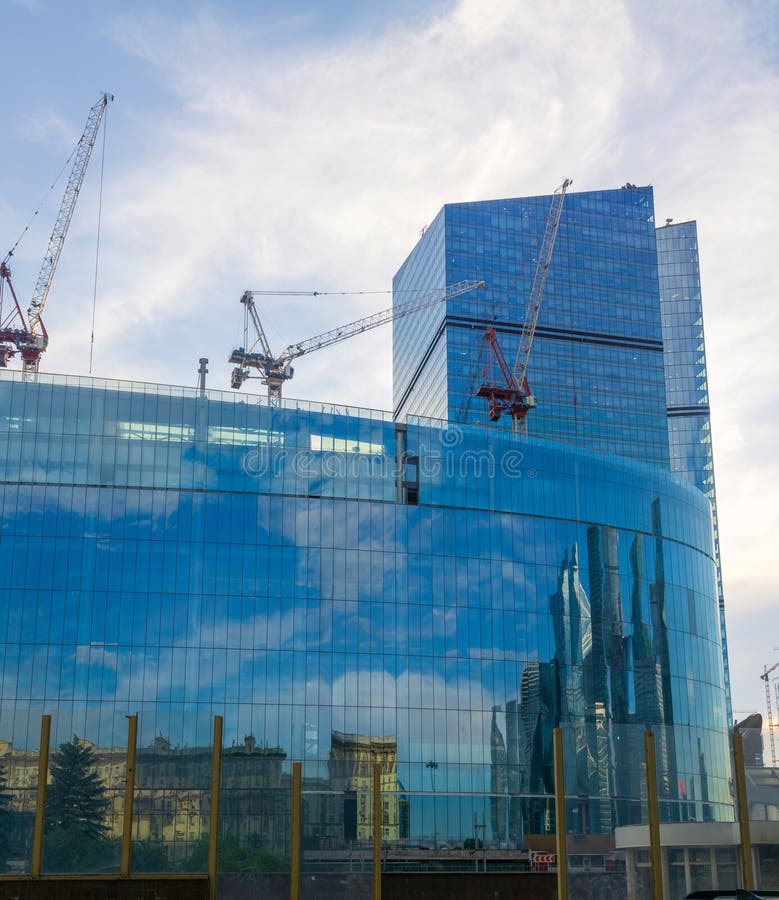 Modern Building with Glass Walls Under Construction in the Blue Sky ...