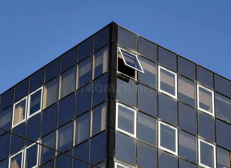 Modern Building with Open and Closed Windows Against Blue Sky Stock ...