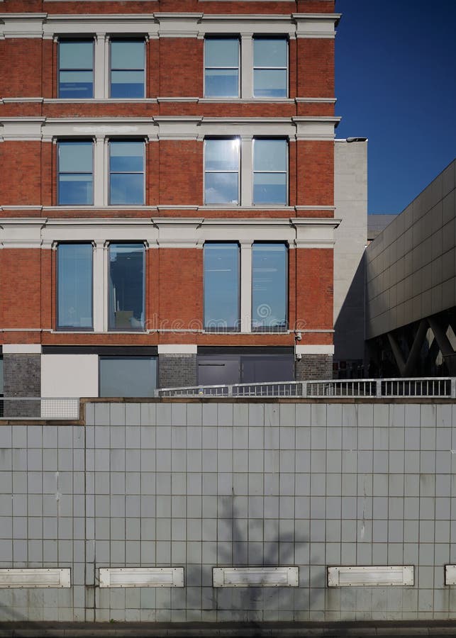 Modern Building with Red Brick Above an Old Tiled Wall Stock Image ...