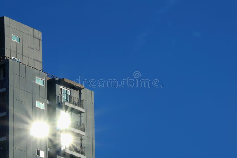 Modern Building with Reflections of Sun Glare Against Vivid Blue Sky ...