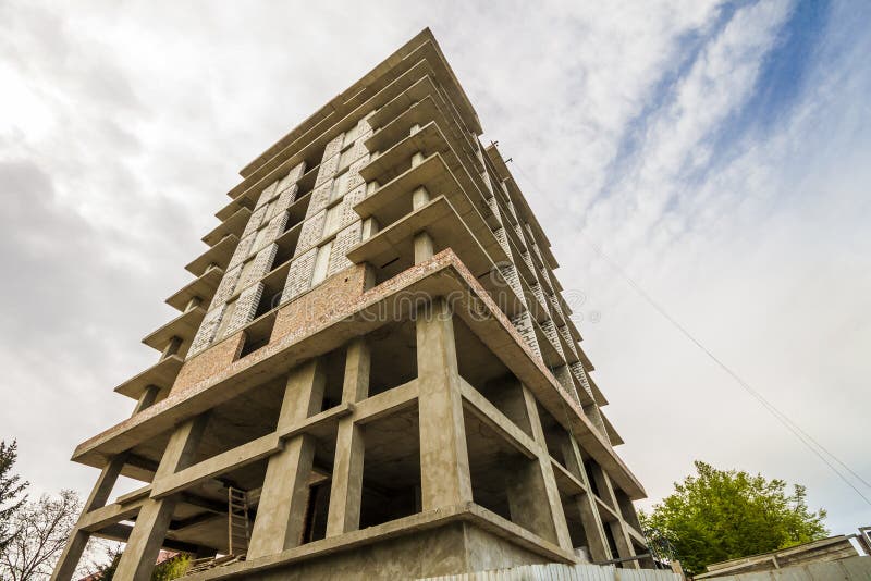 Modern Building Under Construction Against Blue Sky. Construction Work ...