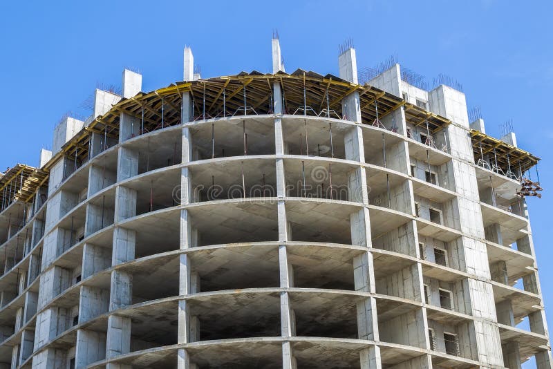 Modern Building Under Construction Against Blue Sky. Construction Work ...