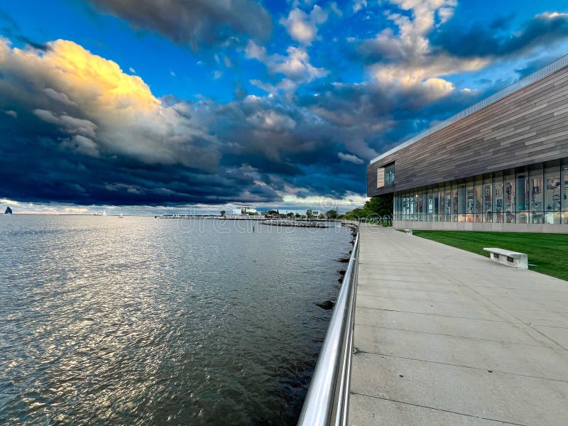 Modern Building by the Waterfront with Dramatic Clouds Stock Photo ...