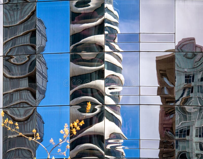 Modern Buildings Reflected in Opposite Windows Resemble Totem Poles ...
