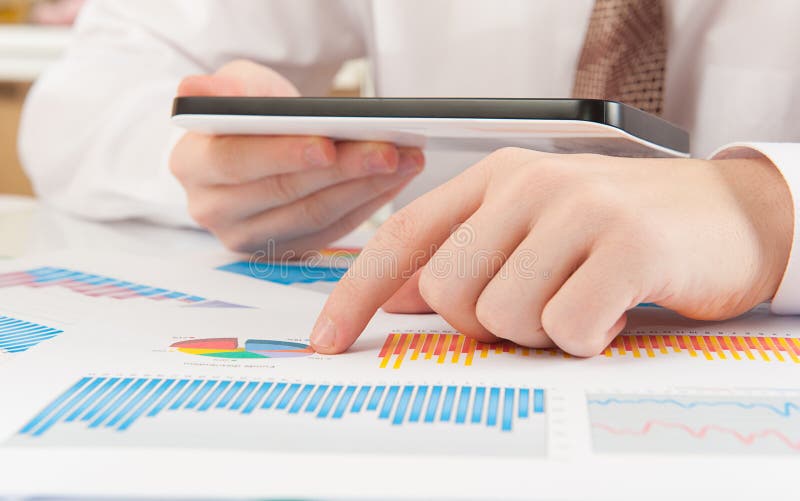 Business Man Working And Analyzing Financial Figures On A Graphs On A ...