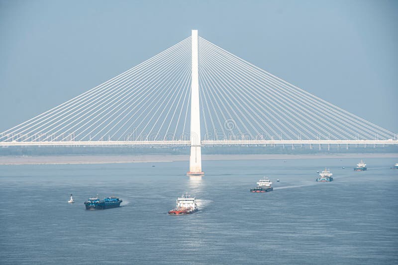 Modern Cable-stayed Bridge with Boats on River. Stock Photo - Image of ...