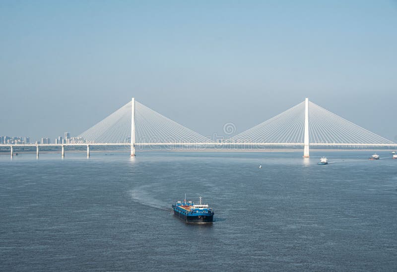 Cable-stayed Bridge with Cargo Ship on River Stock Photo - Image of ...