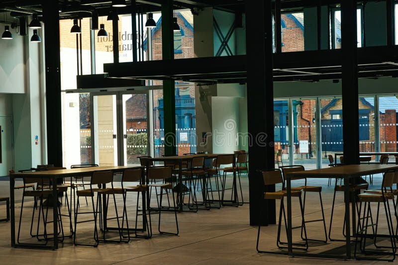 Modern Cafe Interior with Empty Tables and Chairs, Large Windows, and ...