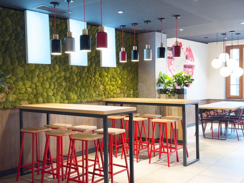 Modern Cafe Interior with Green Moss Wall and Red Bar Stools Editorial ...