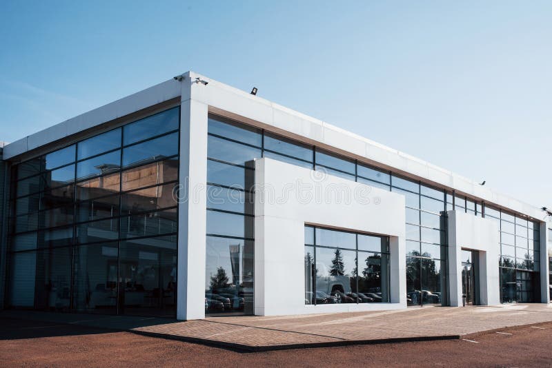 Modern Car Building. Many Vehicles Inside. Sunny Day with Clear Sky ...