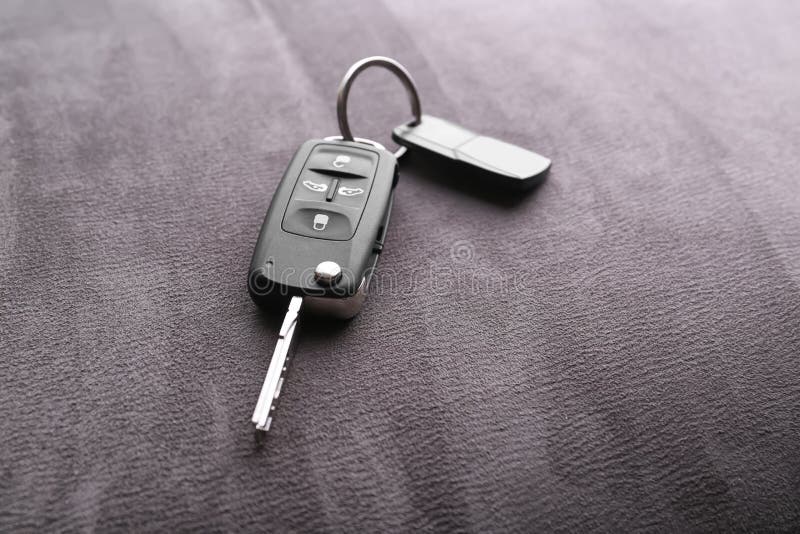 Modern Car Flip Key with Trinket on Grey Fabric Stock Photo - Image of ...