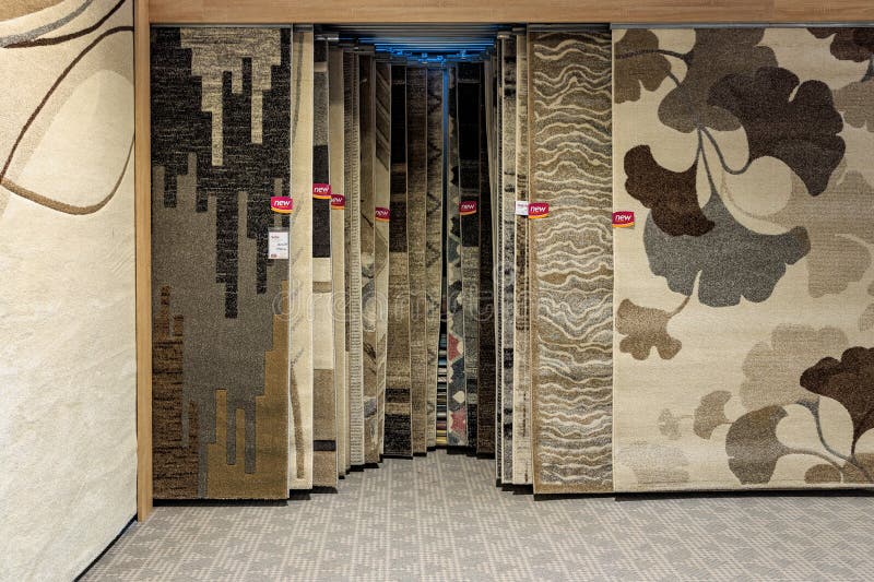 Modern Carpet Display with Various Patterns and Textures in a Showroom ...