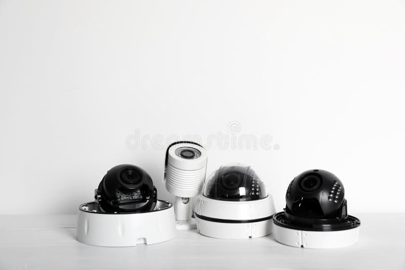 Modern CCTV Cameras On Table Against Light Background Stock Photo ...