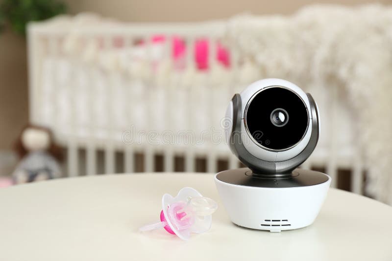 Modern CCTV Security Camera and Pacifier on Table in Nursery Stock ...