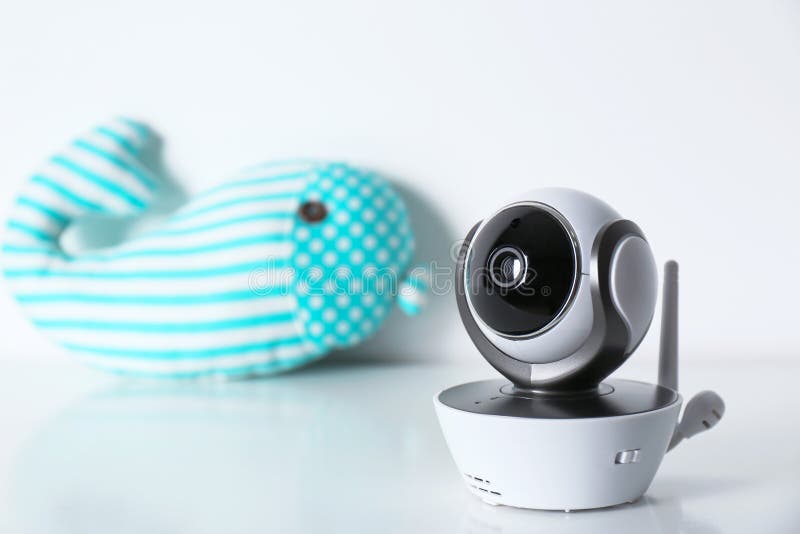 Modern CCTV Security Camera and Toy Whale on Table Against White ...