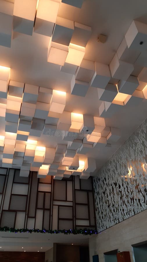 A Modern Ceiling in a Building Features a Grid of Illuminated White ...