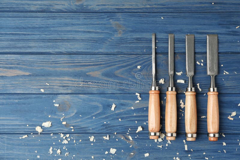 Modern Chisels on Blue Wooden Background, Flat Lay. Carpenter`s Tools ...