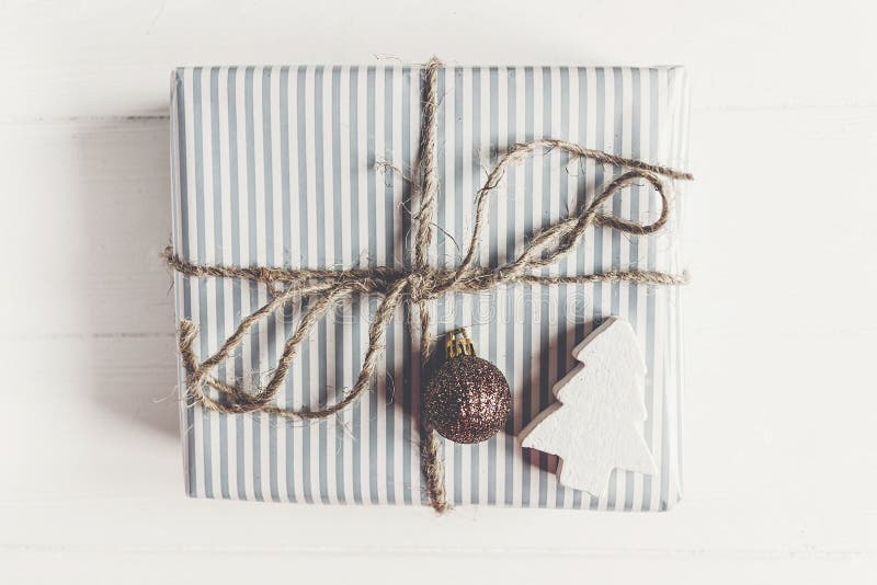 Modern Christmas Wrapped Present with Ornament and Tree on White Stock ...