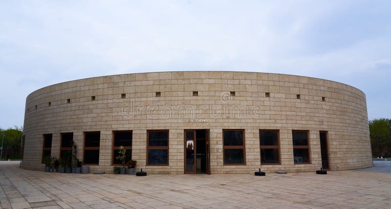 Modern Circular Building with Beige Stone Facade and Large Windows ...