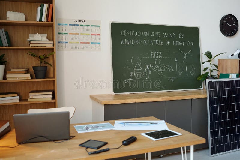 A Modern Classroom with Green Walls, Red Chairs, White Tables, and ...
