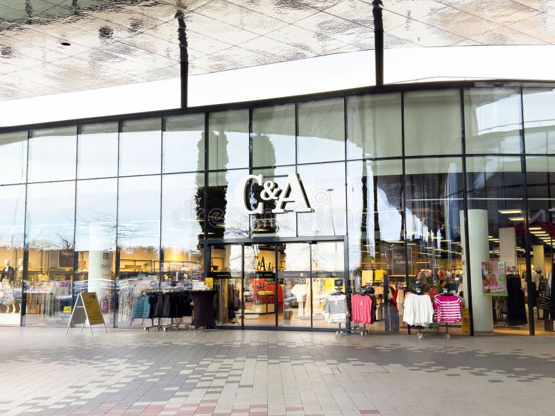 Modern Clothing Storefront with Large Glass Windows and Reflections ...