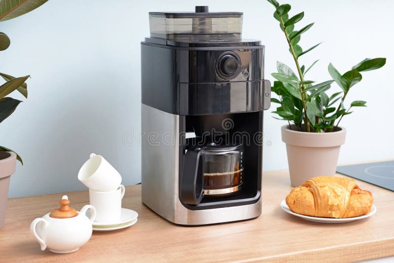 Modern Coffee Machine, Cups and Croissants on Kitchen Table Stock Photo ...