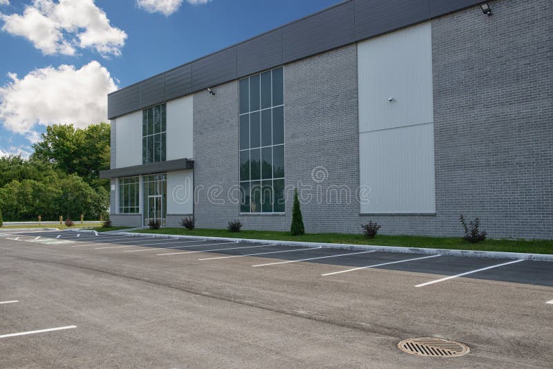 Modern Commercial Building with Large Glass Windows, Gray Brick Facade ...