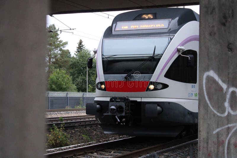 Modern Commuter Train on Rails with Trees in the Background Stock Photo ...