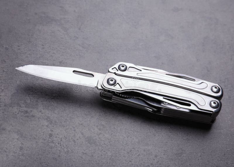Modern Compact Portable Multitool on Grey Table Stock Image - Image of ...