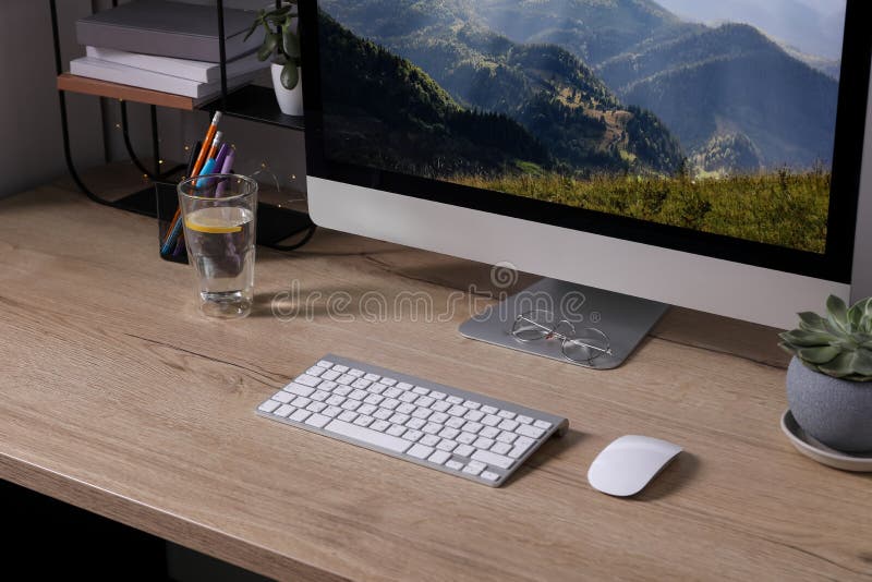 Modern Computer and Glass of Lemon Water on Wooden Table Indoors Stock ...