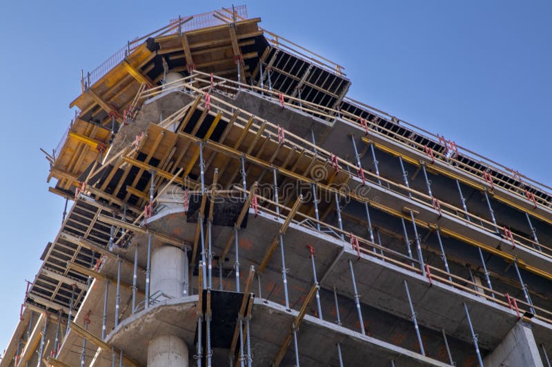 A Modern Concrete Building Under Construction, Featuring Scaffolding ...