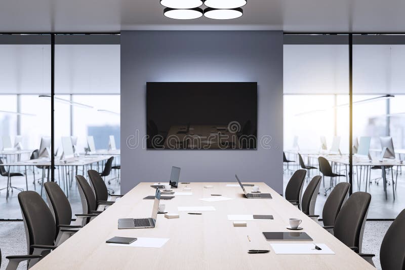 Modern Conference Room with a Long Table, Laptops, and Chairs in a ...