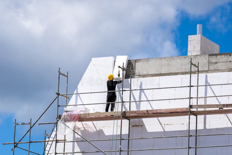 Man Installing Styrofoam Sheets on House Facade Wall for Thermal ...