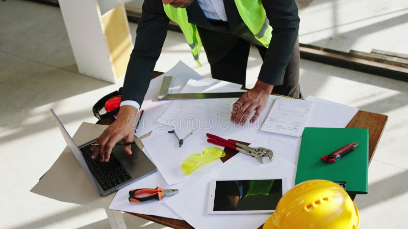 At Modern Construction Site Architect Man Analysing the Plan of ...